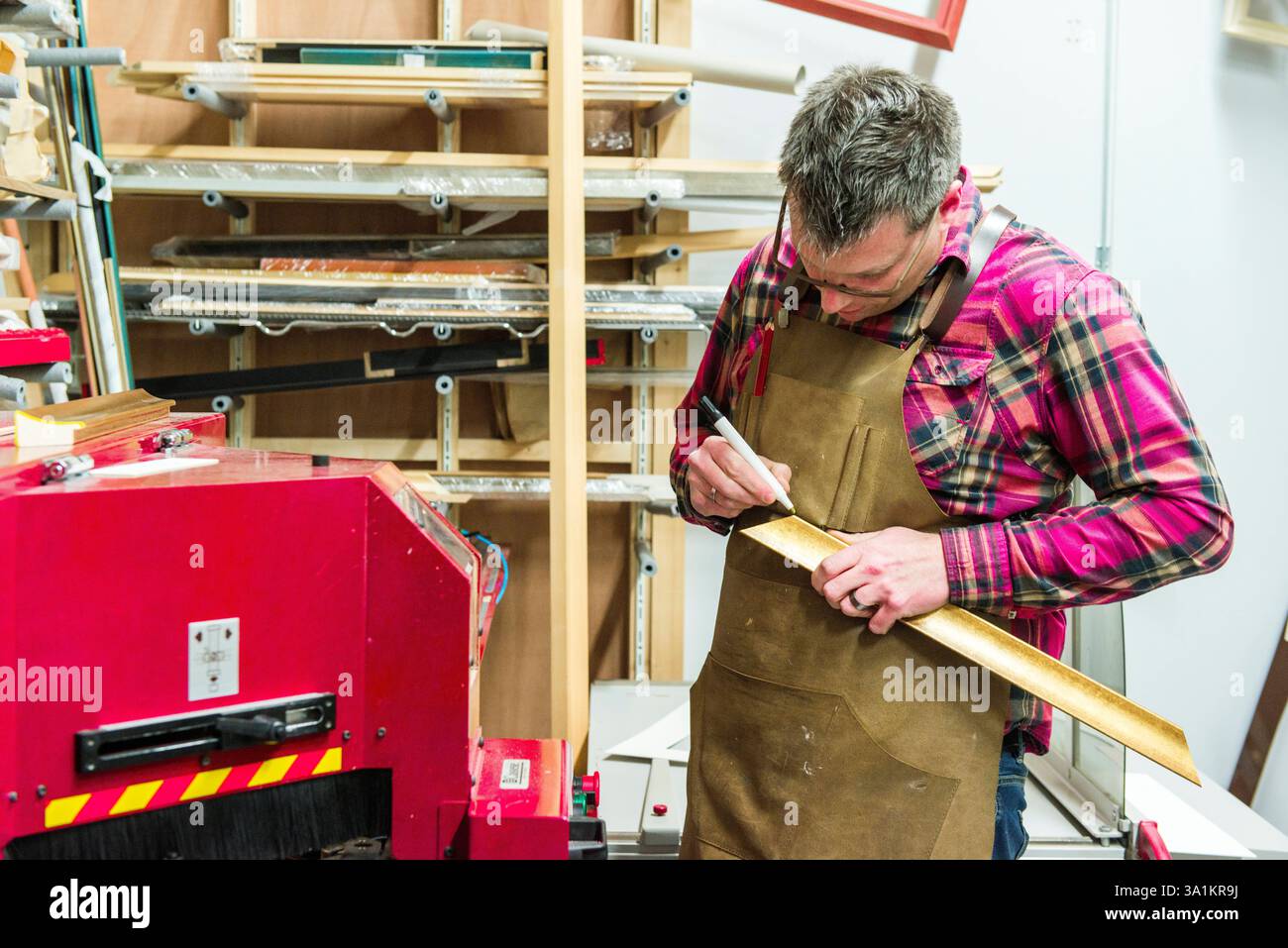 Framemaker inside his workshop Goirle, Netherlands. Mid adult male craftsman and picture ...