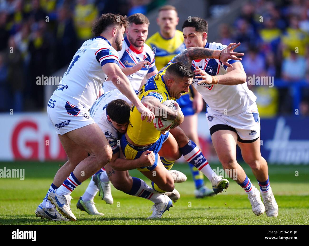 Warrington Wolves' Paul Vaughan tackled by Wakefield Trinity's Caleb ...