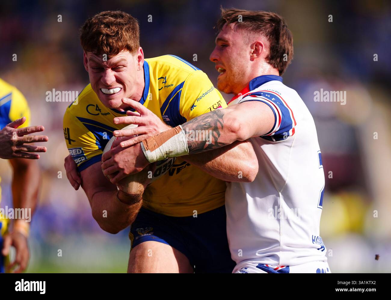 Warrington Wolves' Dan Russell tackled by Wakefield Trinity's Jack ...
