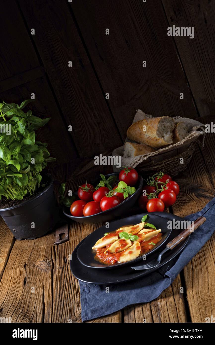 Rustic Delicious Pasta - Ravioli in tomato sauce with basil Stock Photo ...
