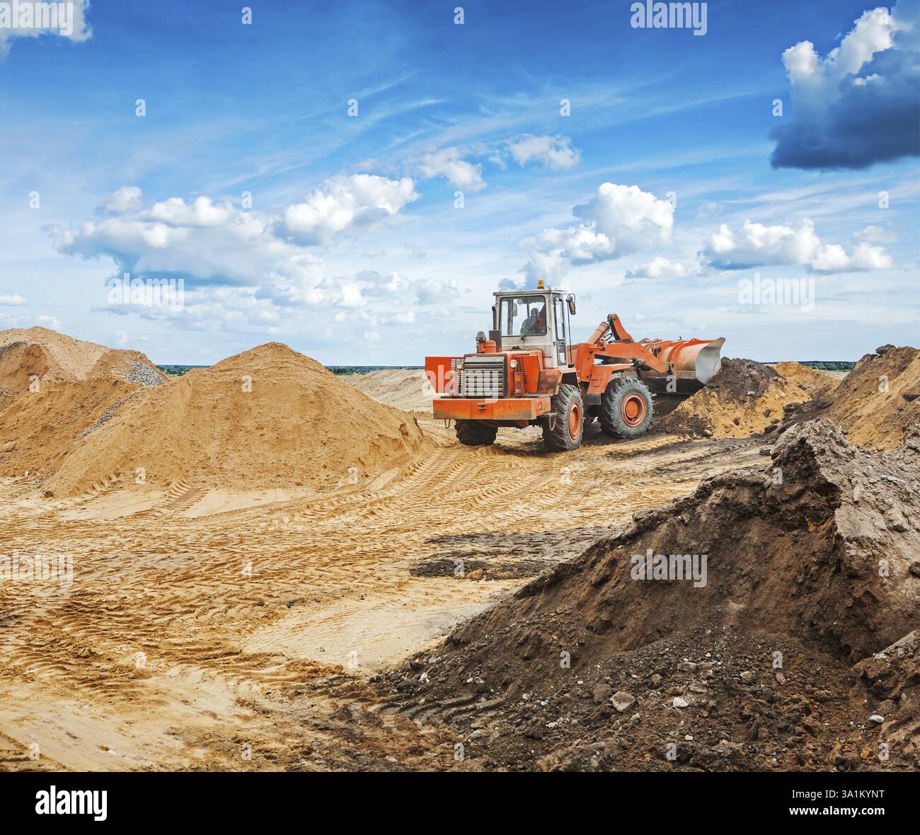Old roadworking tractor working with construction sand Stock Photo - Alamy