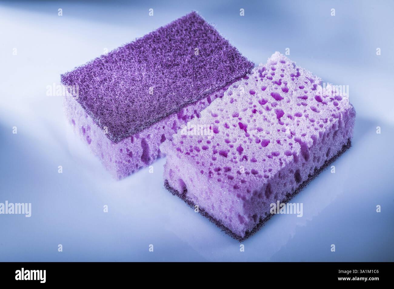 New violet cleaning sponges on white background Stock Photo - Alamy