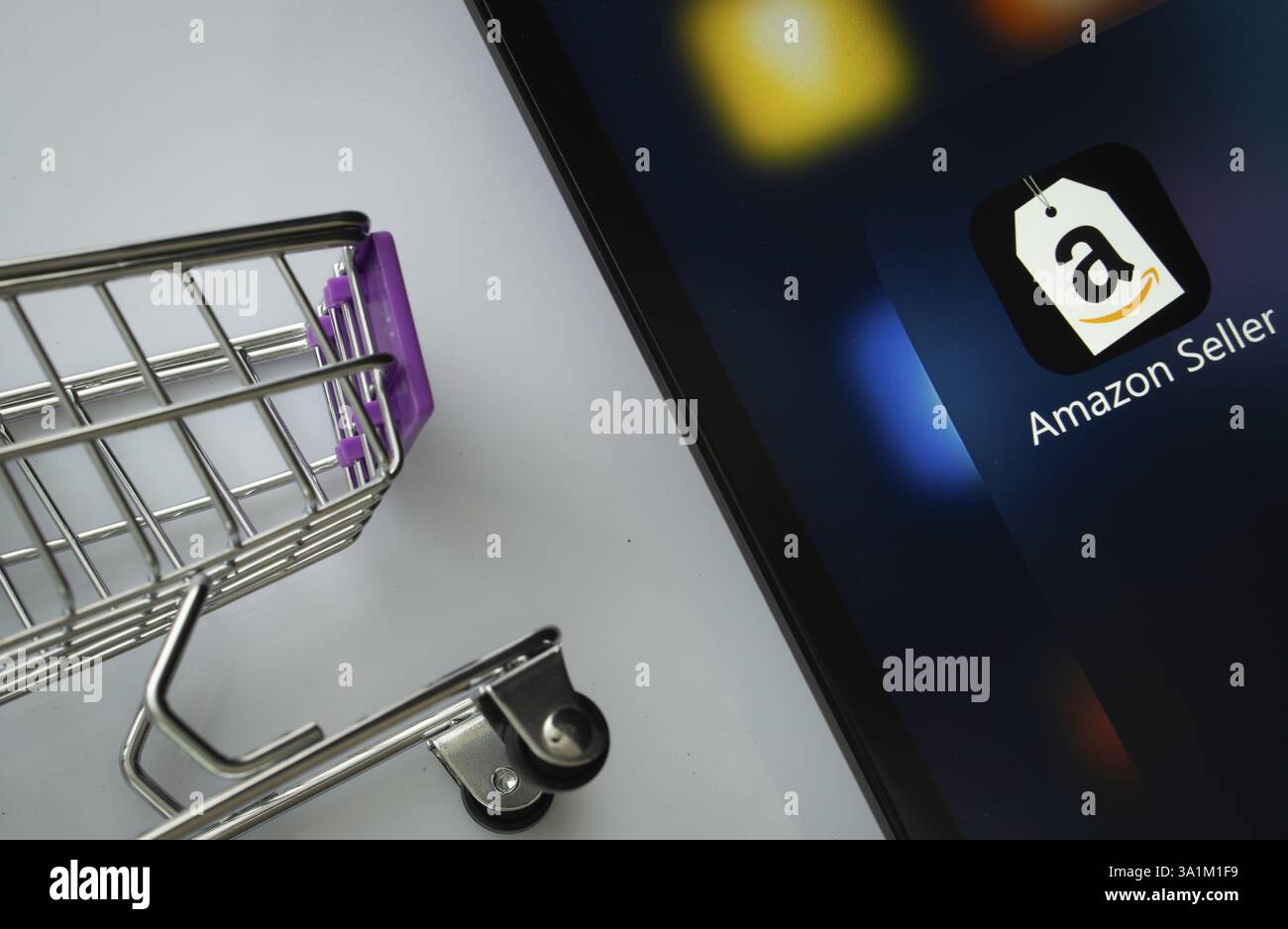 A close up of an iPad screen displaying the amazon seller app alongside ...