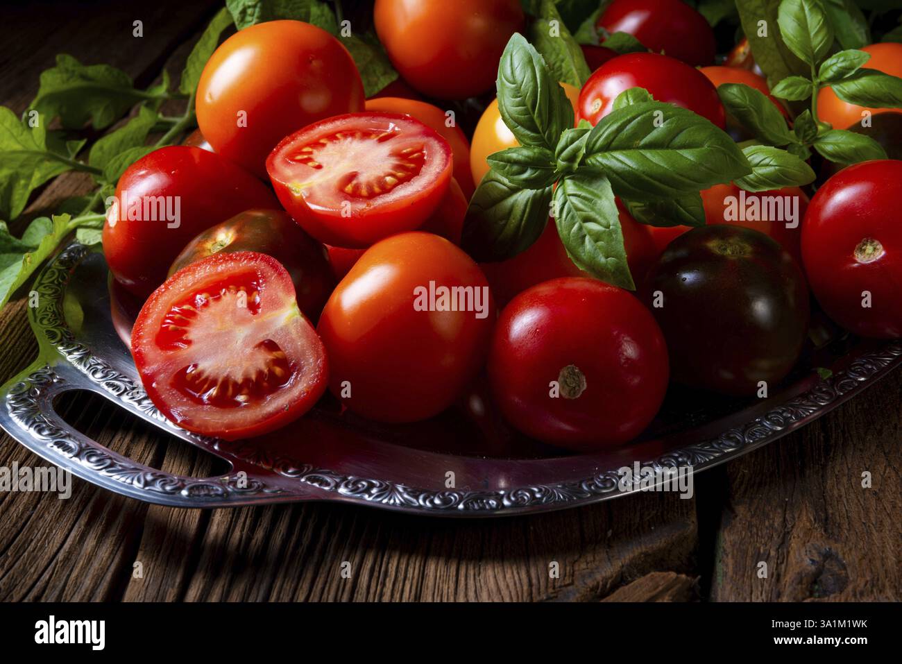 Various types of tomatoes served and presented on the silver platter ...