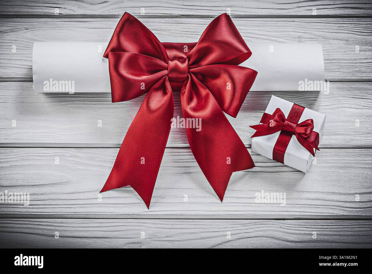Paper roll with red bow present box holidays concept Stock Photo - Alamy