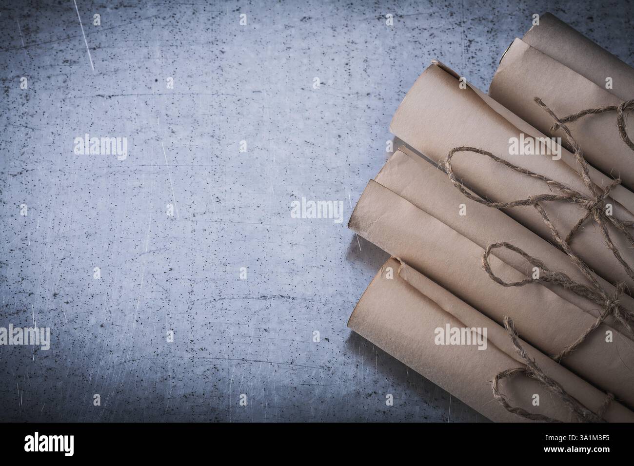 Pile of vintage paper scrolls on scratched metallic background Stock ...