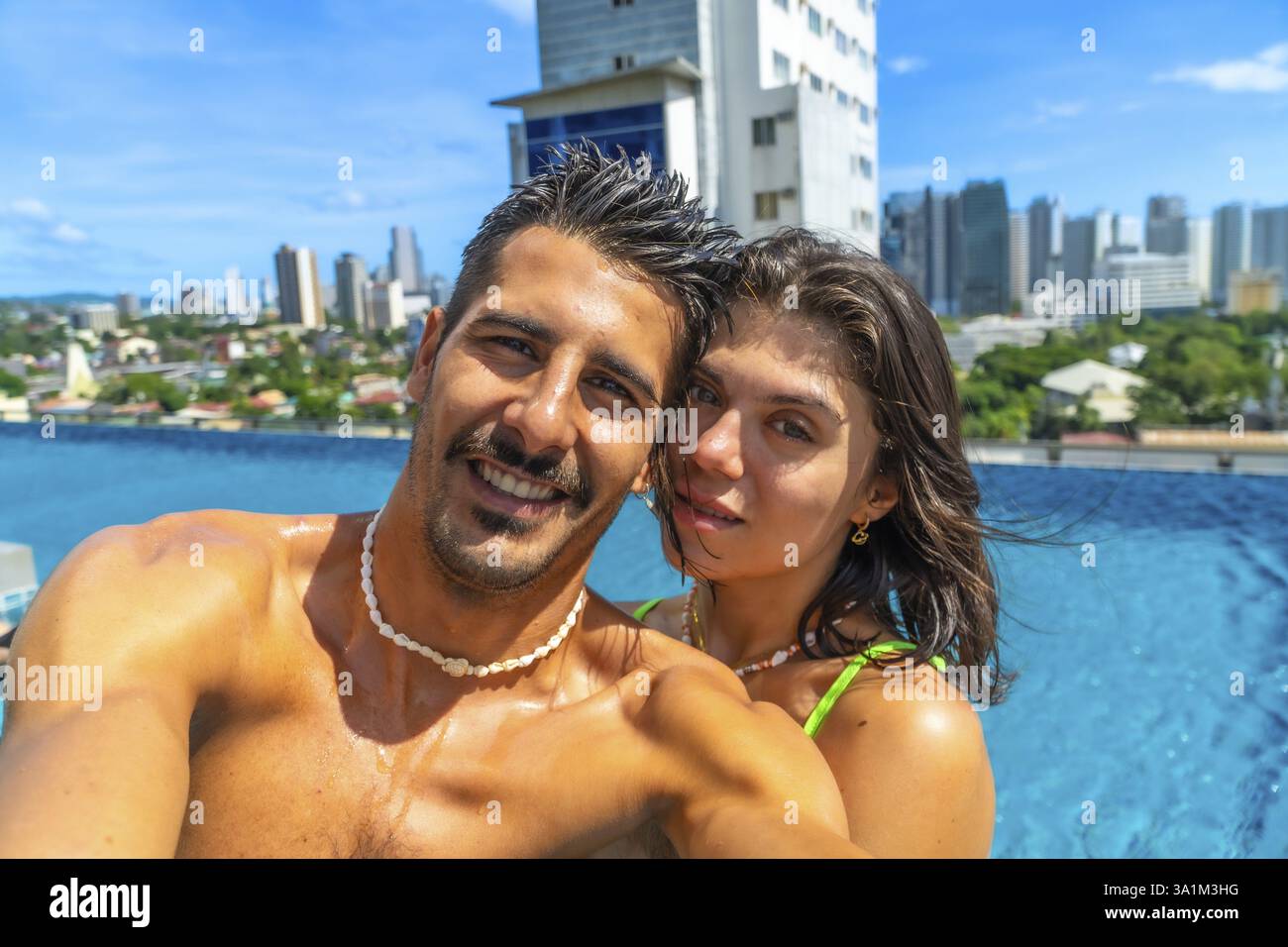 Tourists enjoying holidays in a rooftop swimming pool in cebu city ...