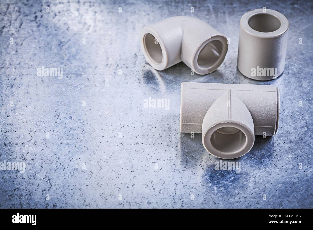 Plastic pipe connectors on metallic surface construction concept Stock ...