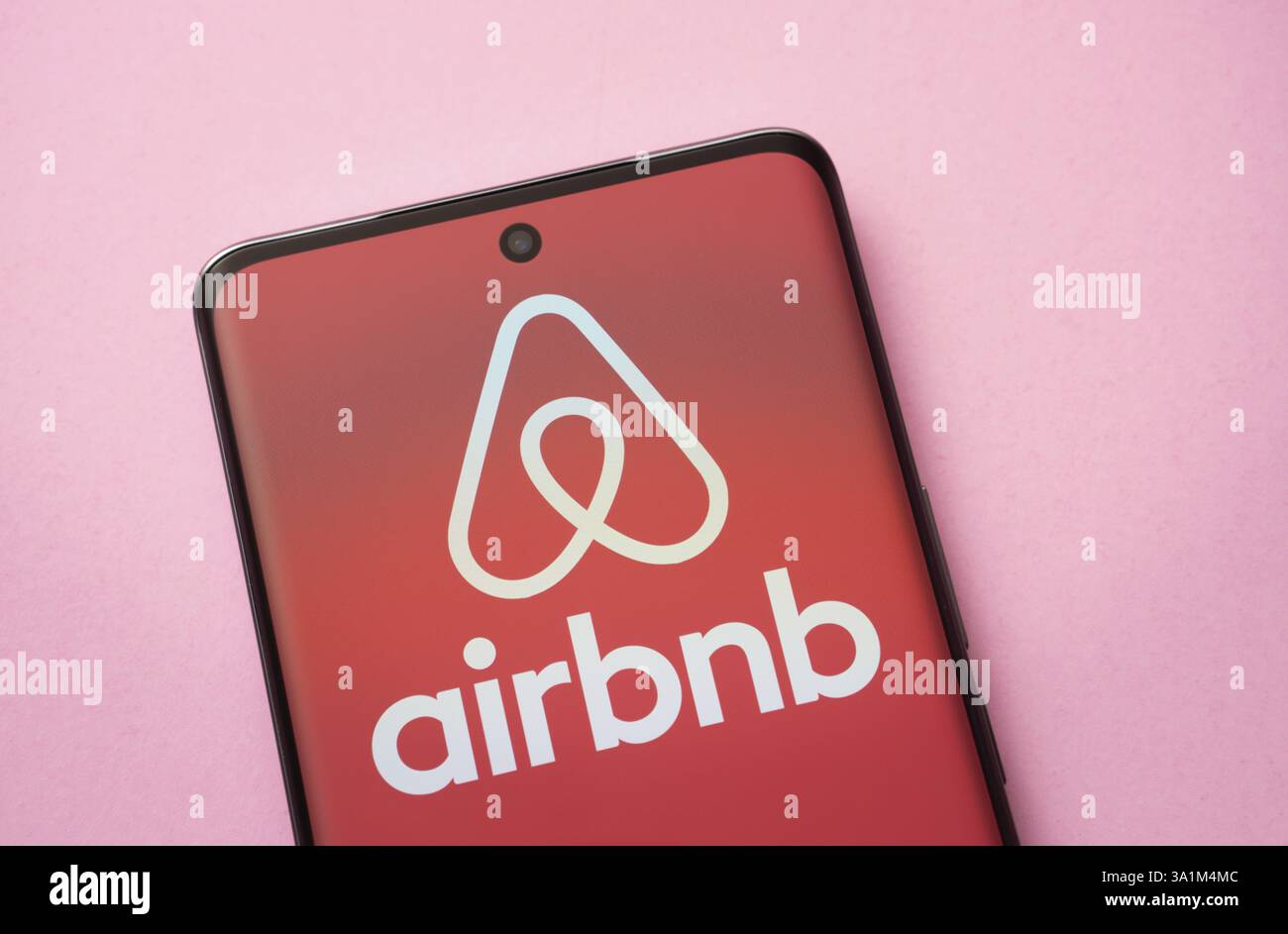 Airbnb logo is seen on a smartphone Stock Photo - Alamy