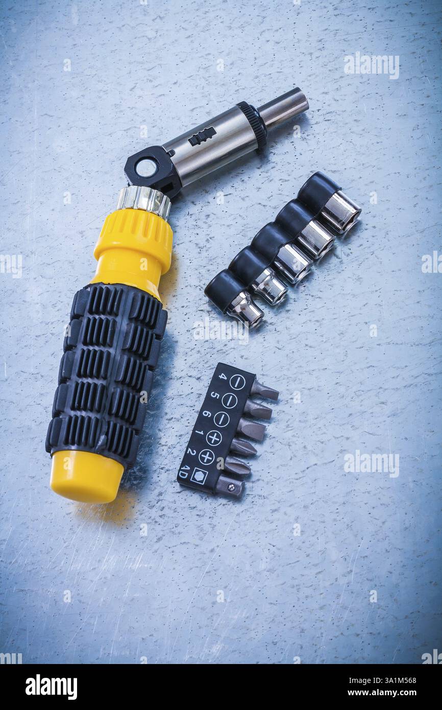 Reversible turnscrew screwdriver bits and torxes on metallic background ...