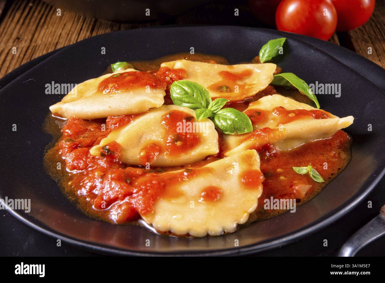 Rustic Delicious Pasta - Ravioli in tomato sauce with basil Stock Photo ...
