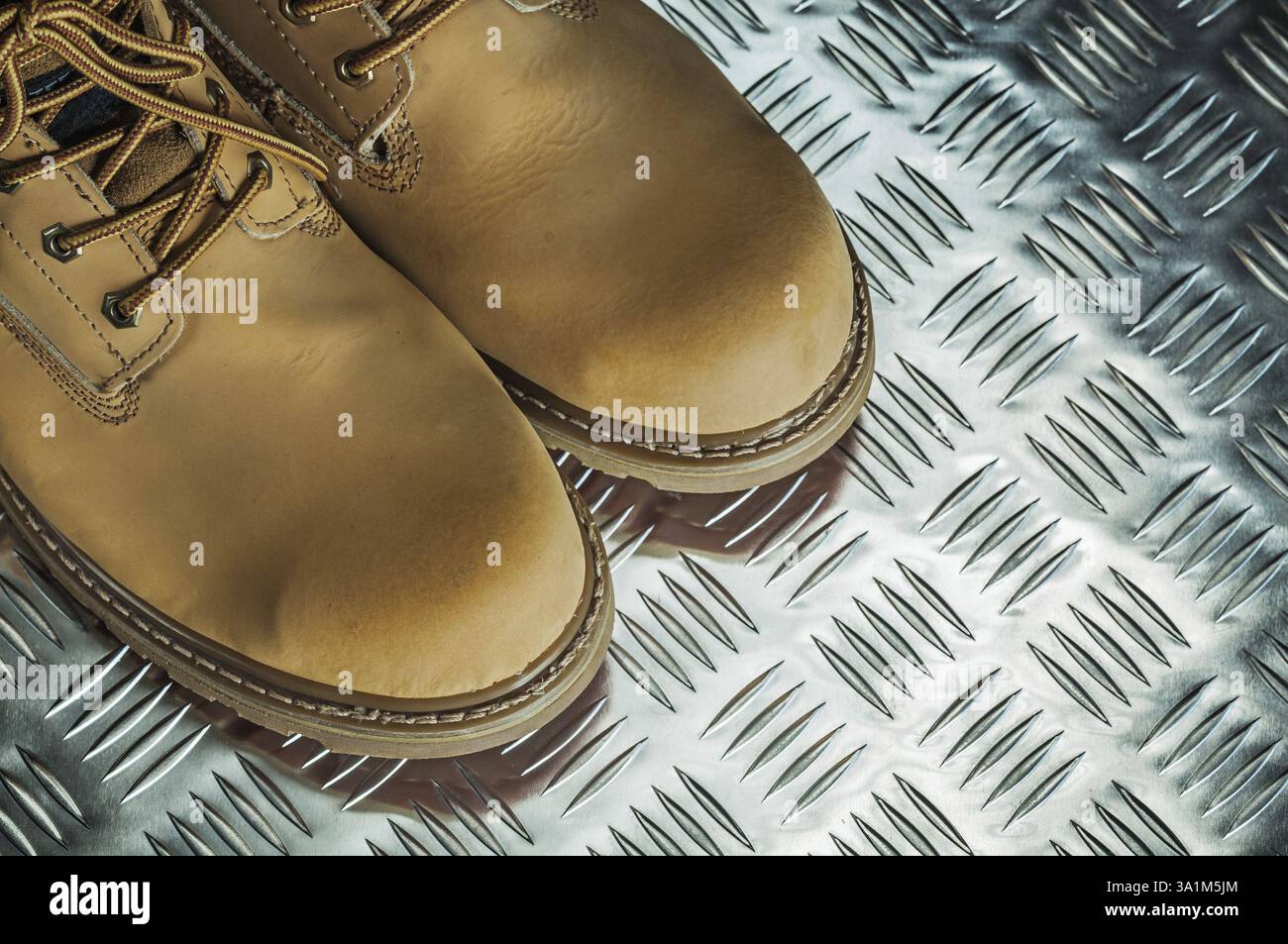 Pair of leather safety boots on corrugated metal plate Stock Photo - Alamy