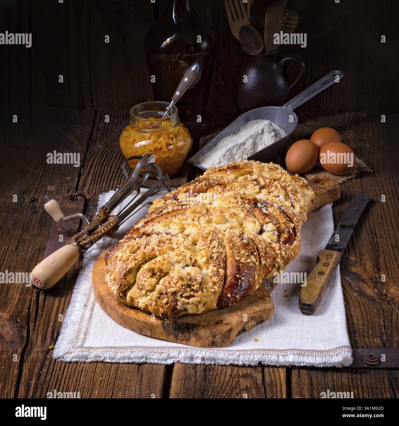 Braided yeast bun with egg and butter Stock Photo - Alamy