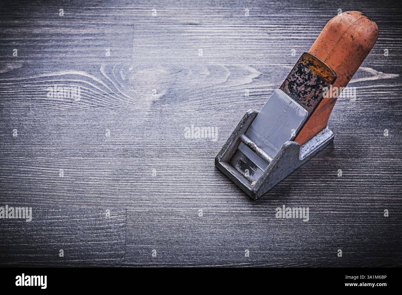 Mini vintage block shaving plane on wood board construction concept ...