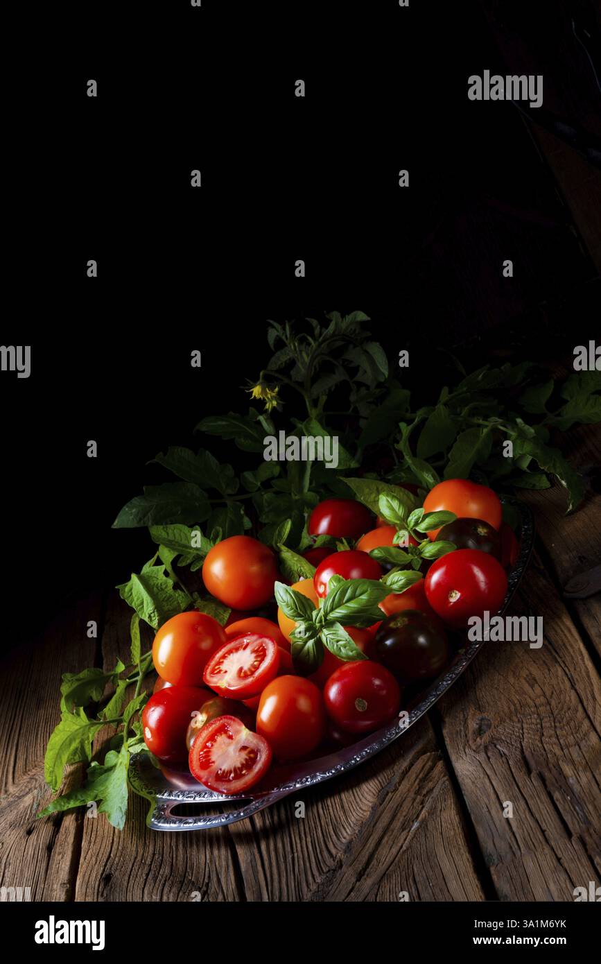 Various types of tomatoes served and presented on the silver platter ...