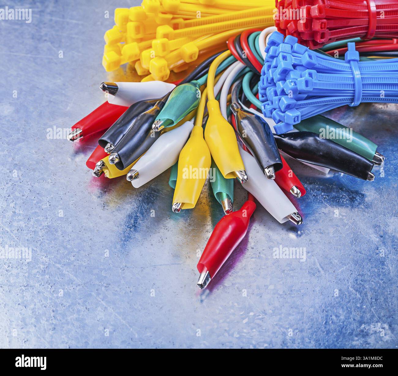 Plastic tying cables electric crocodile plugs on scratched metallic ...