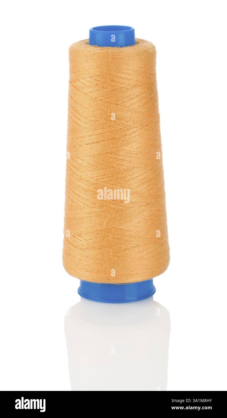 Orange thread on blue Spool Stock Photo - Alamy