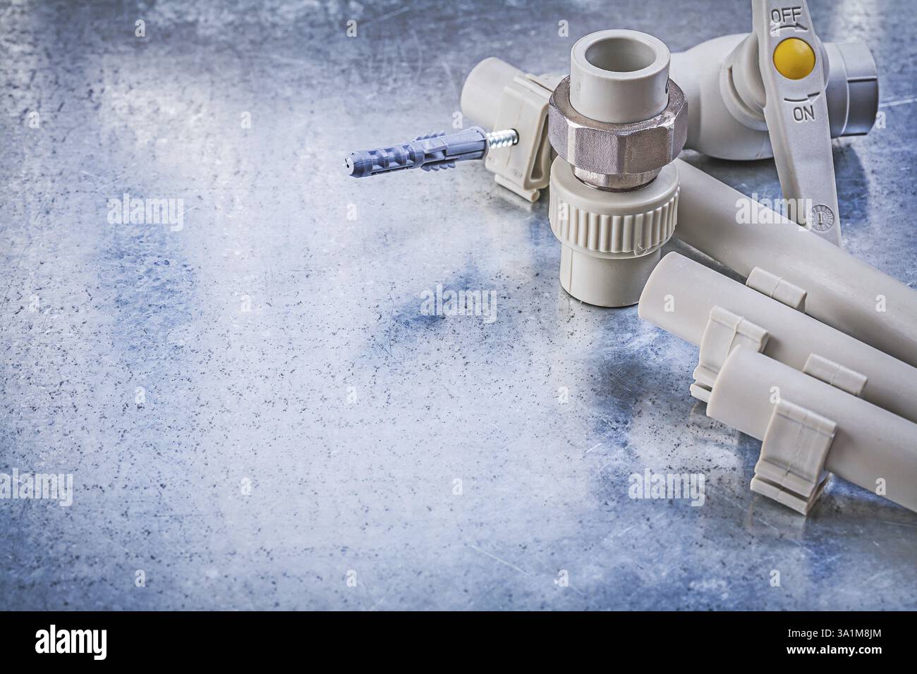Plastic water pipe valve clamps connectors on metallic background ...