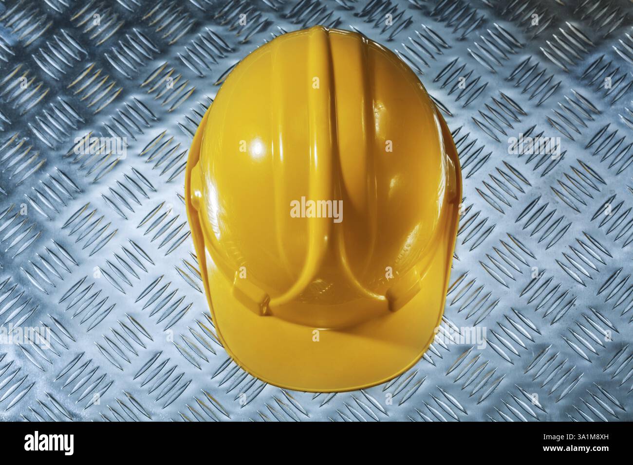 Protective building helmet on grooved metal sheet Stock Photo - Alamy