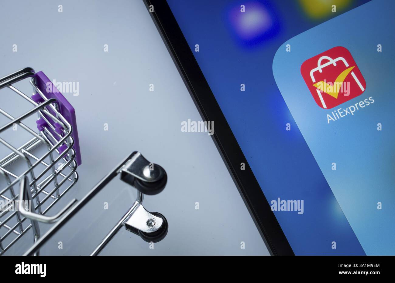 A close up of an iPad screen displaying the AliExpress app alongside a ...