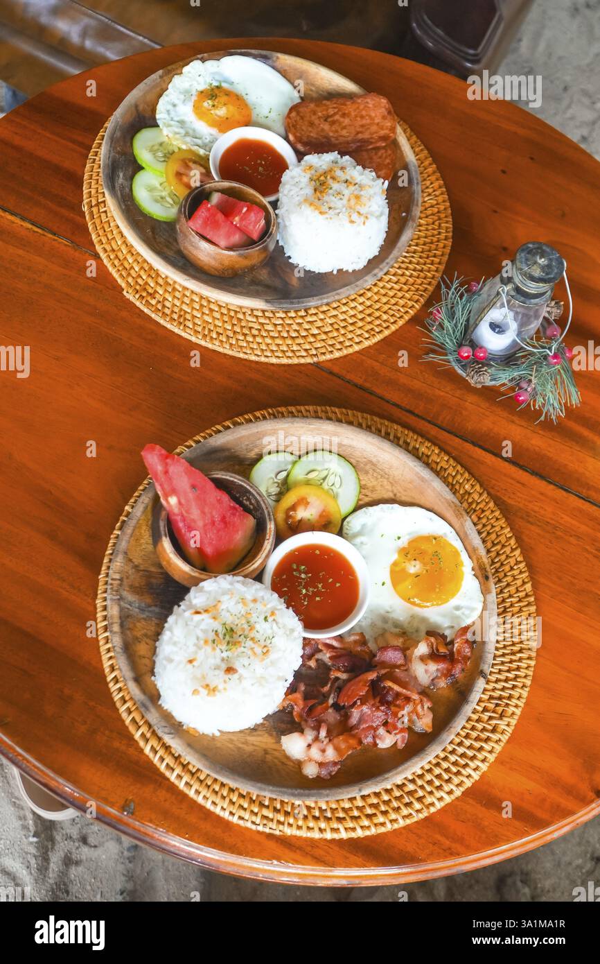 Two plates featuring filipiNA breakfast with fried eggs, rice, meat ...