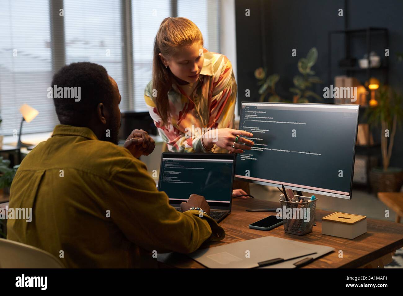 Colleagues Typing Codes In Team Stock Photo - Alamy