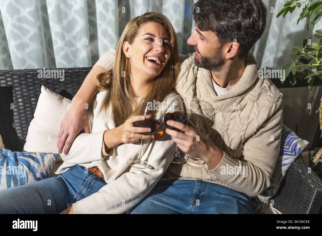 Romantic couple enjoying a relaxing evening together, sharing drinks ...