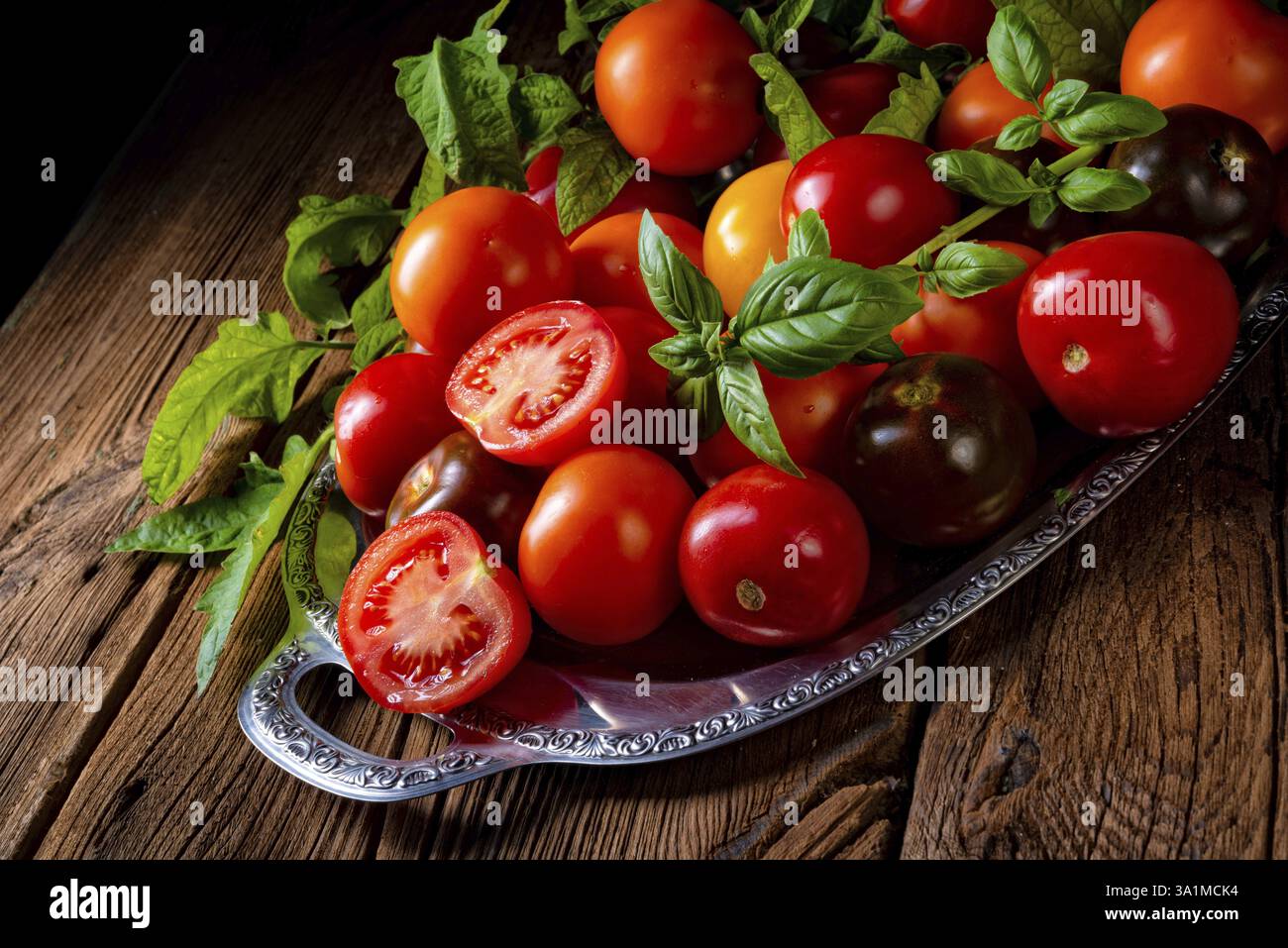 Various types of tomatoes served and presented on the silver platter ...
