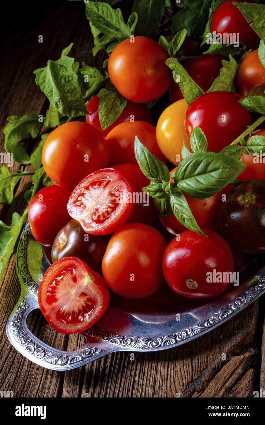 Various types of tomatoes served and presented on the silver platter ...