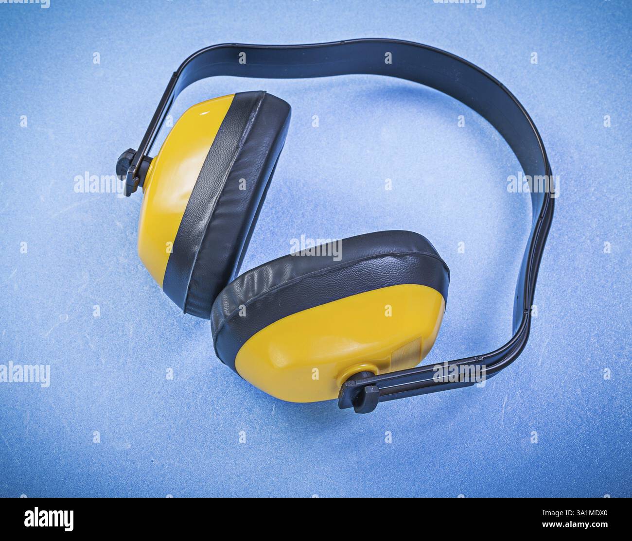 Protective ear muffs on blue background construction concept Stock ...