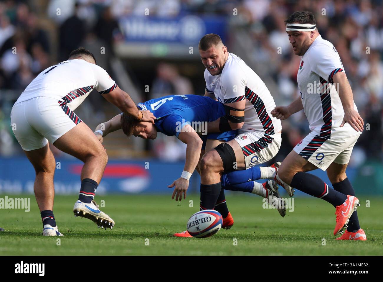 Italy's Stephen Varney,, enter, is tackled by England's Ellis Genge ...