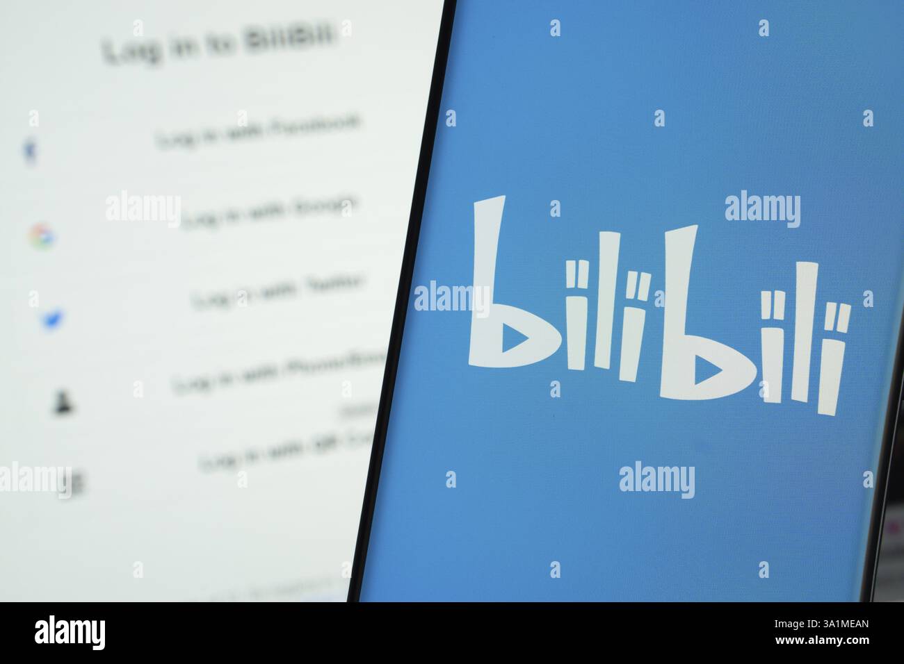 Bilibili logo is displayed on a smartphone screen, with the bilibili ...