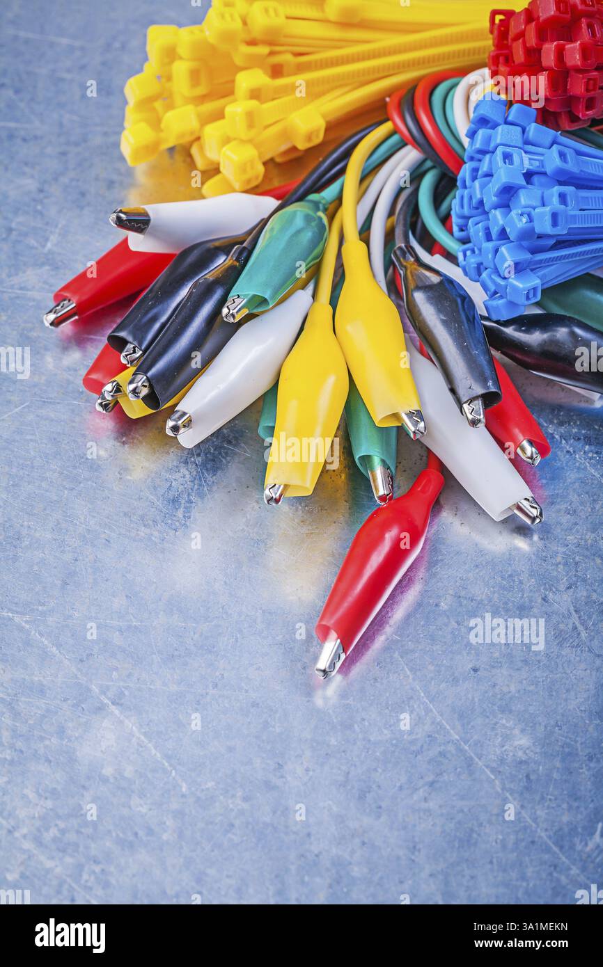 Plastic cable ties electric crocodile plugs on scratched metallic ...