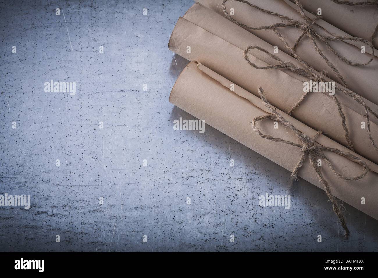 Pile of vintage paper rolls on scratched metallic surface Stock Photo ...