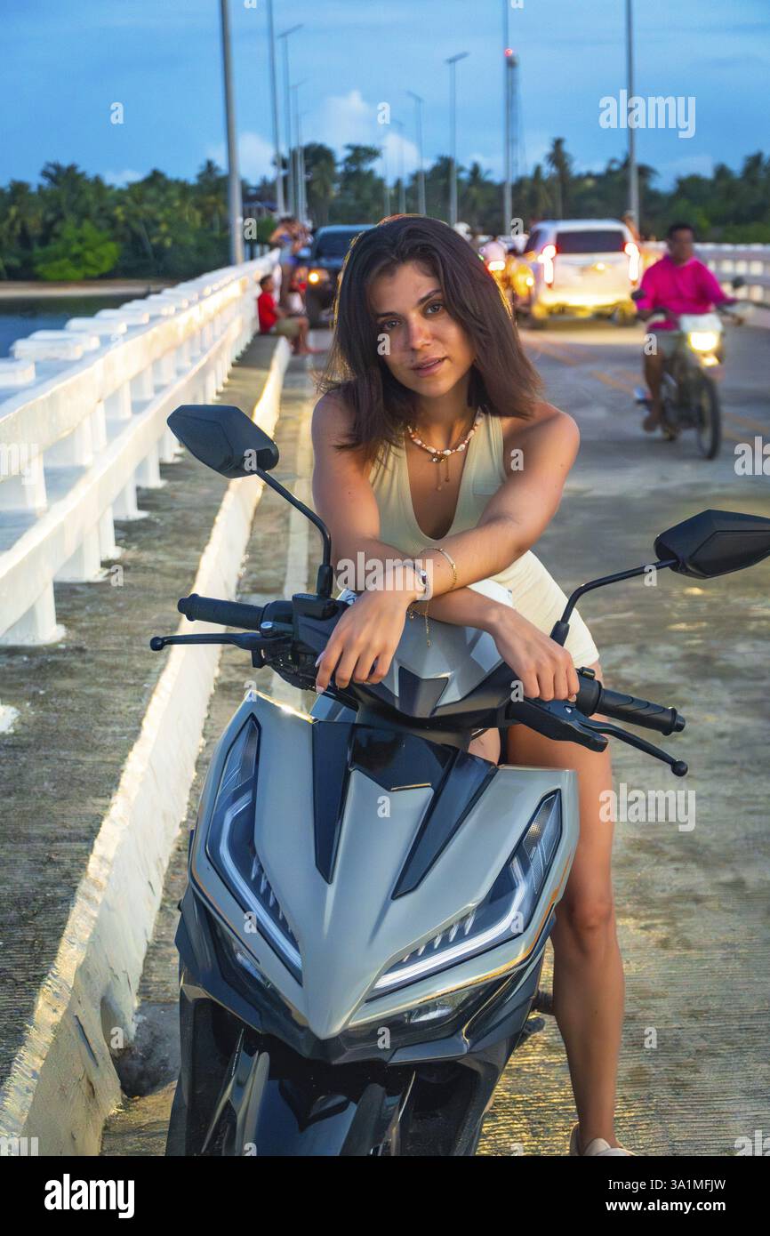 Tourist enjoying her scooter on afam bridge, siargao island ...