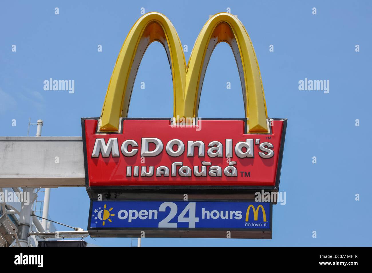 Pattaya, Thailand - 5 May, 2009: A McDonald's sign glows with its 24 ...