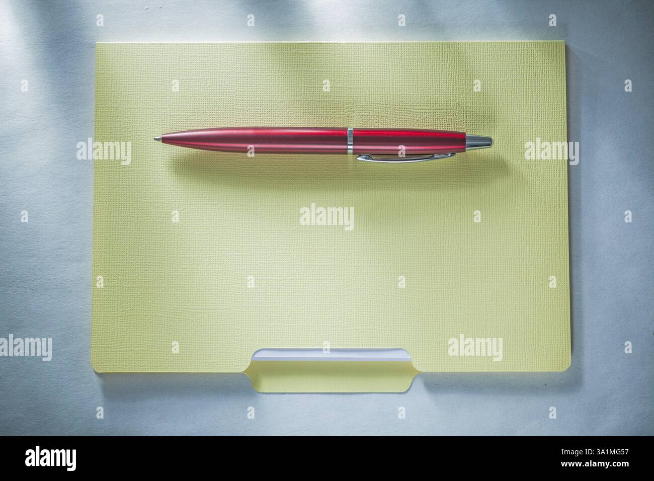 Paper folder biro pen on white background Stock Photo - Alamy