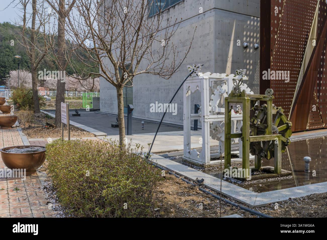 Hwanggan, South Korea, April 10, 2020: Two wooden waterwheels in front ...