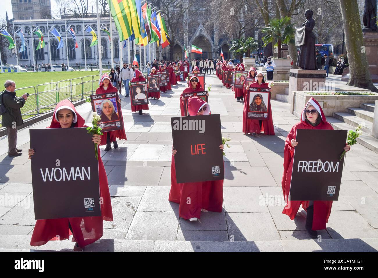 London, UK. 8th March 2025. Women wearing The Handmaid's Tale costumes ...