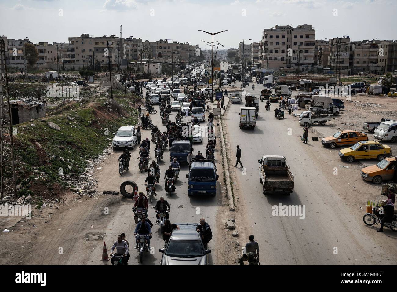 09 March 2025, Syria, Hama: Syrian fighters and civilians attend the ...
