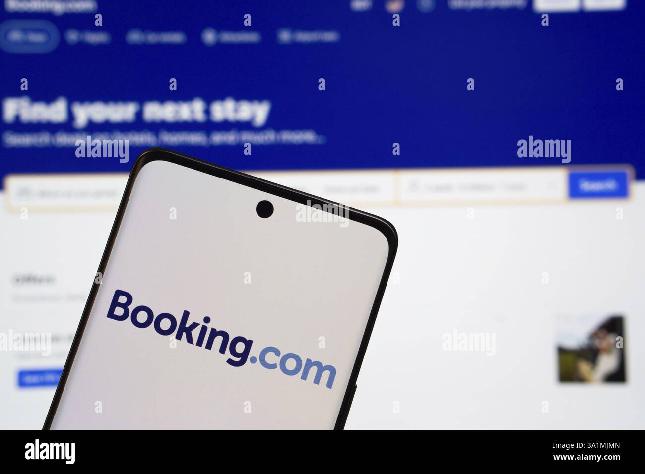 Booking.com logo is displayed on a smartphone screen, with the booking ...