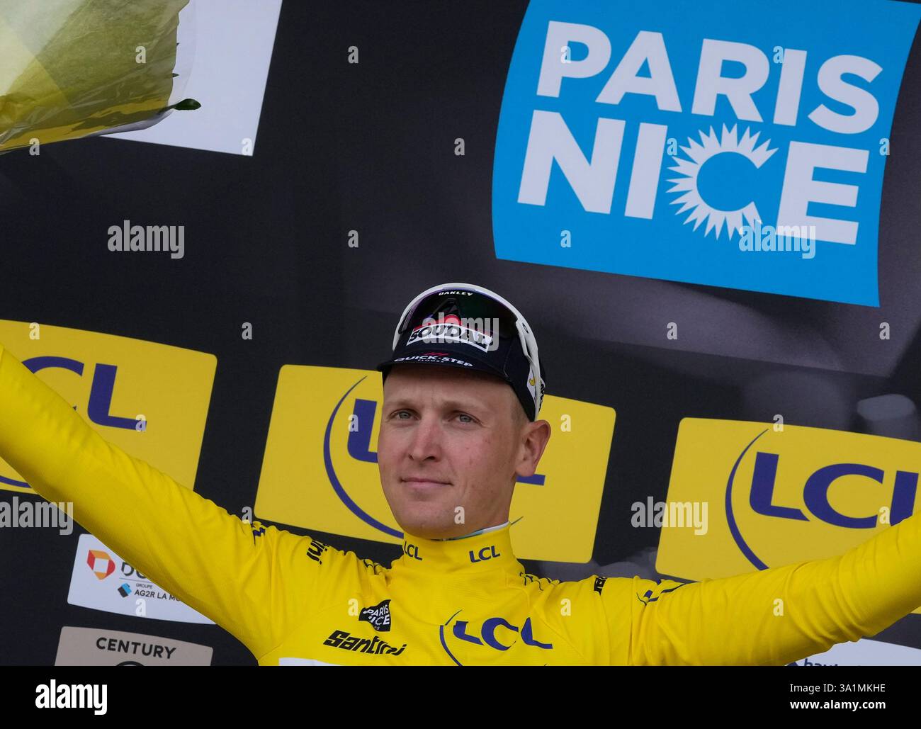 Belgium's Tim Merlier wearing the overall leader's yellow jersey ...