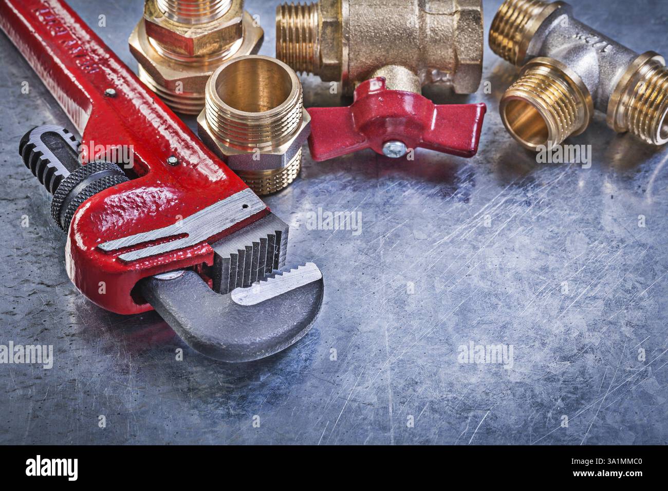 Monkey wrench brass plumbing fittings gate valve on metallic background ...