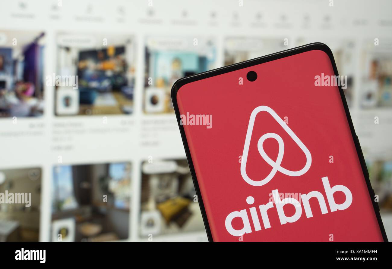 Airbnb logo is seen on a smartphone Stock Photo - Alamy