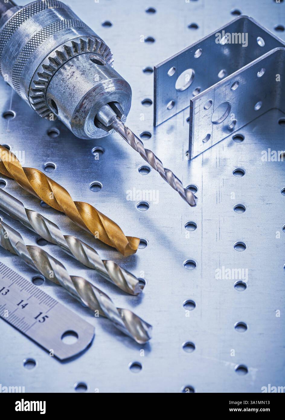 Perforated angle fasteners metal ruler drill and bits on metallic ...