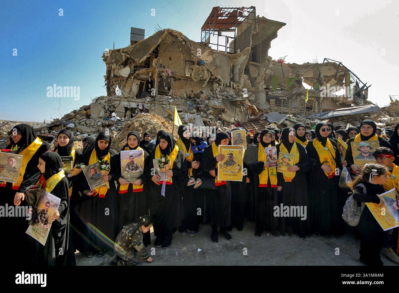 Kfarkela, Lebanon. 09th Mar, 2025. Shia Muslim Women carry pictures of ...