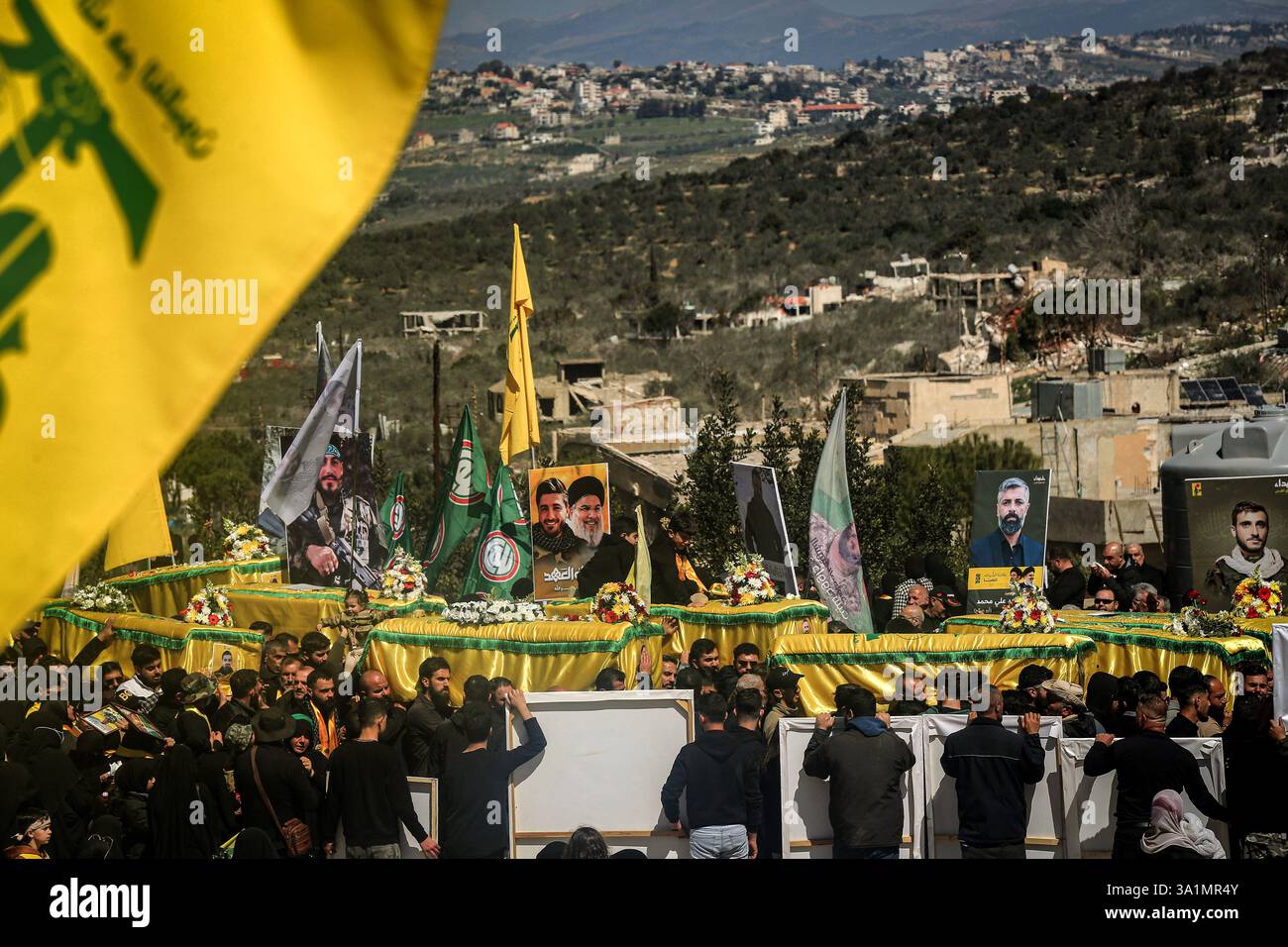 Kfarkela, Lebanon. 09th Mar, 2025. Mourners carry coffins of pro ...