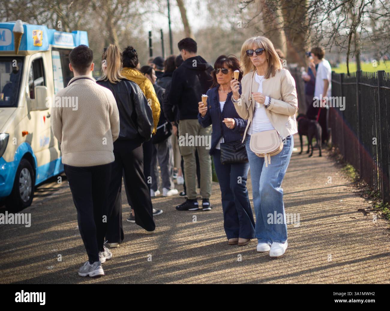 People enjoy ice cream near Primrose Hill, central London. The UK ...