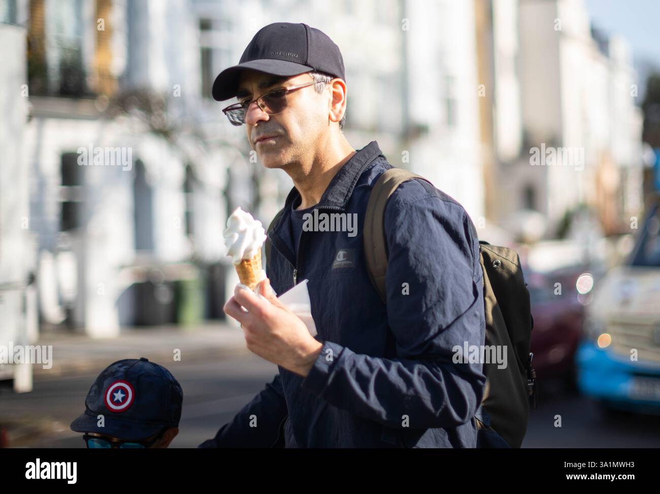 A man holds an ice cream near Primrose Hill, central London. The UK ...