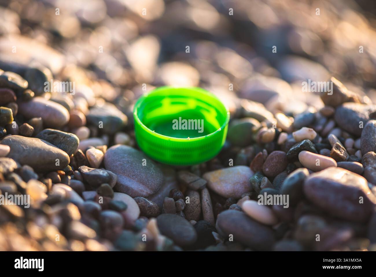 plastic bottle cap on the beach, environmental pollution Stock Photo ...